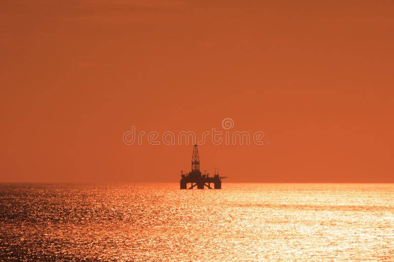 Offshore Oil Rig during Sunset Stock Photo - Image of land, machinery ...
