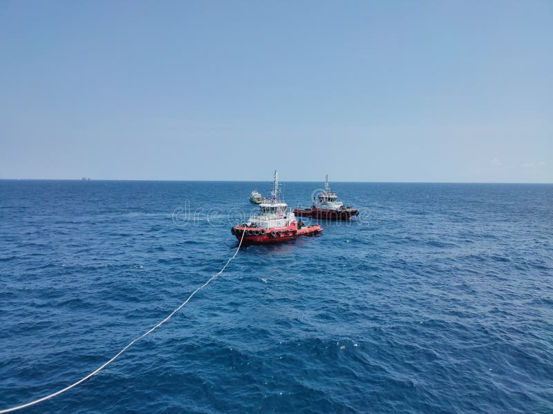 Red Tugboat Pulling a Ship editorial stock photo. Image of tugboat ...