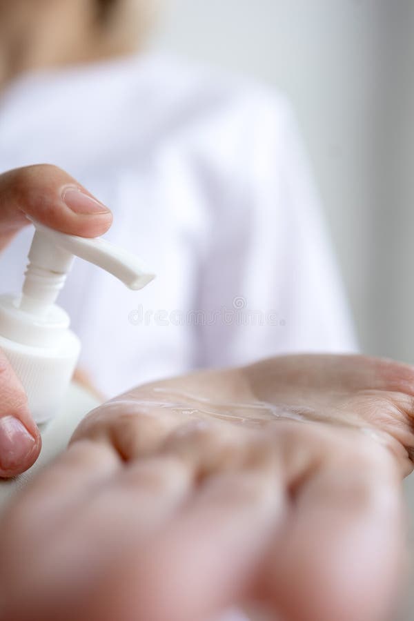 Oil from a Bottle with a Dispenser Squeeze into the Palm of Your Hand ...