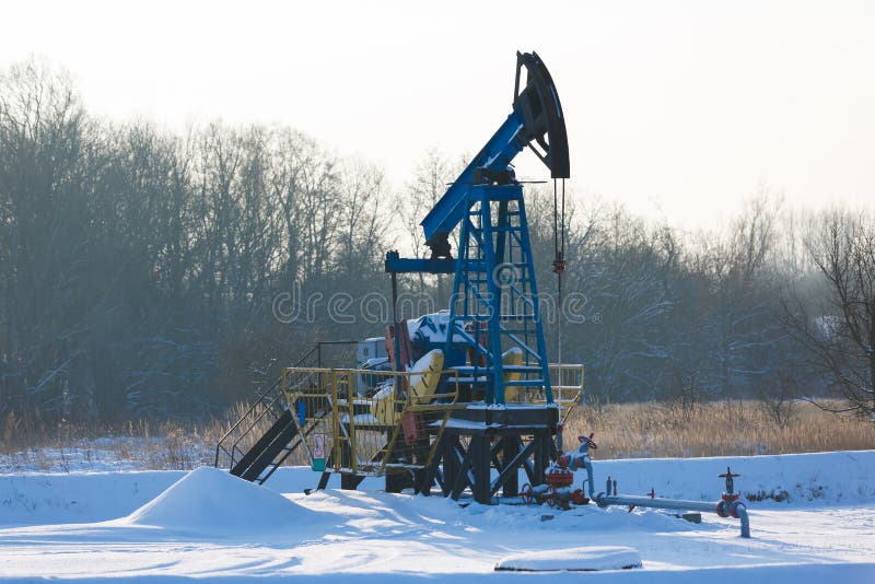 Oil derricks in winter stock image. Image of machinery - 65602361