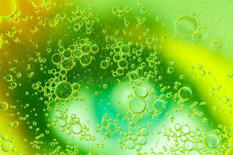 Oil Drops Floating in Water Abstract Green Color Background. Stock ...