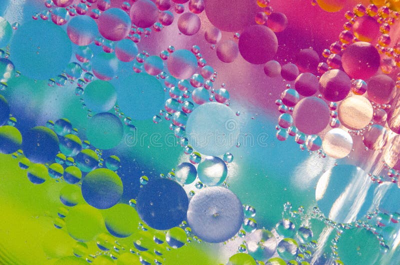 Oil drops on water surface stock image. Image of light - 127415545