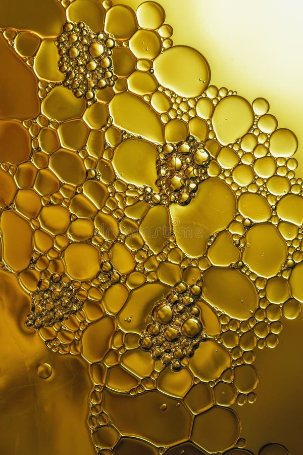 Oil Floating on Yellow Background Stock Photo - Image of floating ...