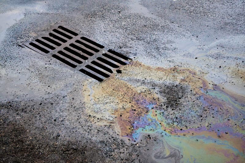 An Oil Slick of Gasoline or Oil on an Asphalt Road Flows into a Storm ...