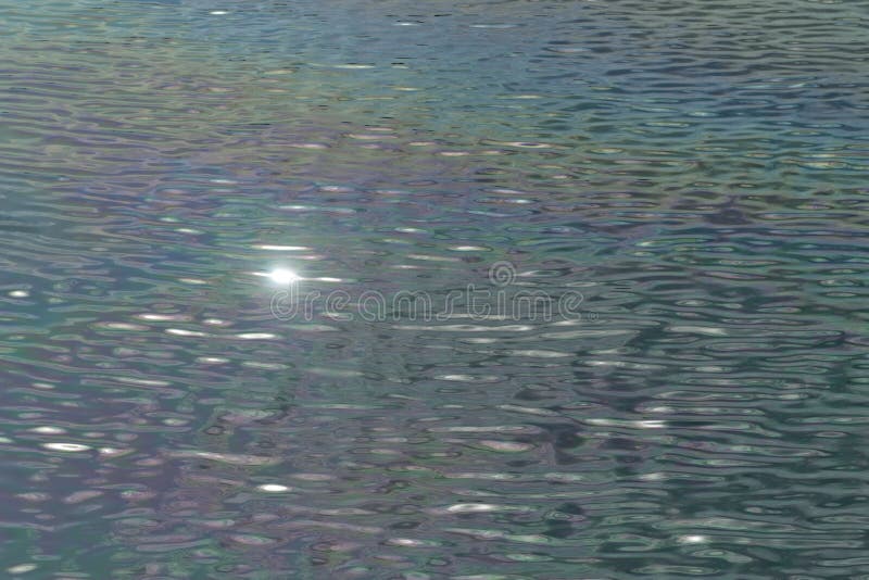 Oil on glowing water stock photo. Image of sunlight - 166321910
