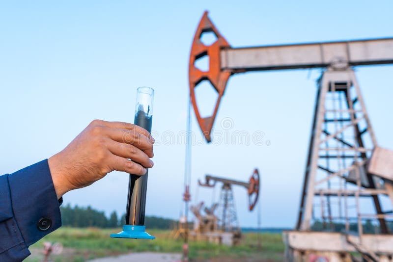 Oil Industry. a Test Tube with Crude Oil in the Hand of an Engineer ...