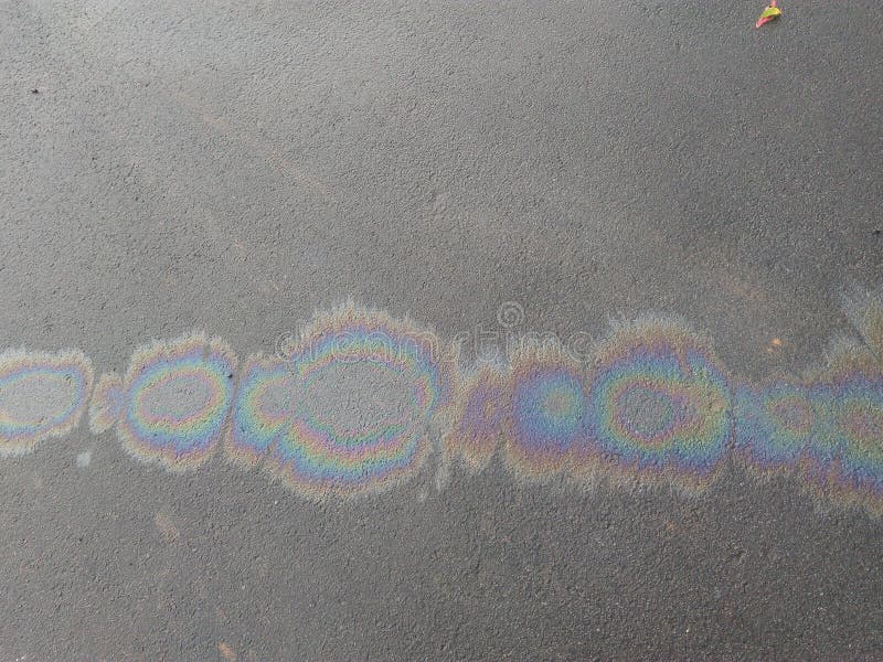 Oil marks in the street stock image. Image of colored - 111810351