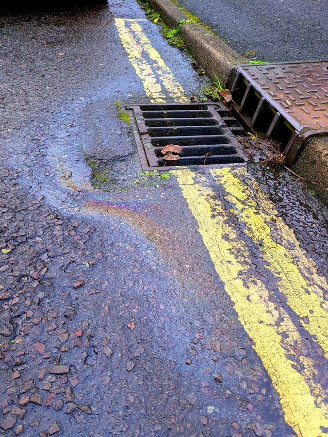 Oil Petrol Environmental Rainbow Leak Running Down a Drain Stock Photo ...
