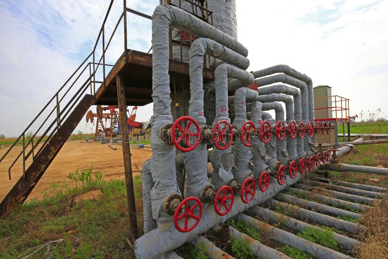 Oil pipes and valves stock photo. Image of refinery - 346431426