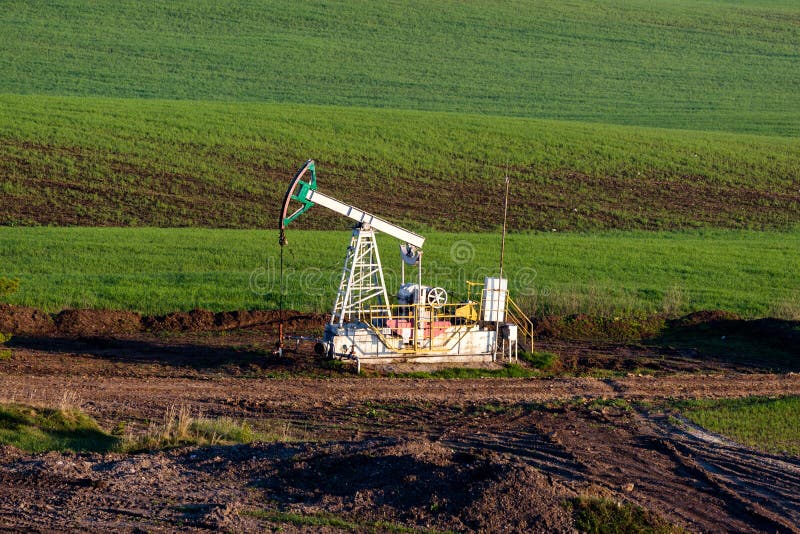 Oil pump in the field stock image. Image of industry - 74488447