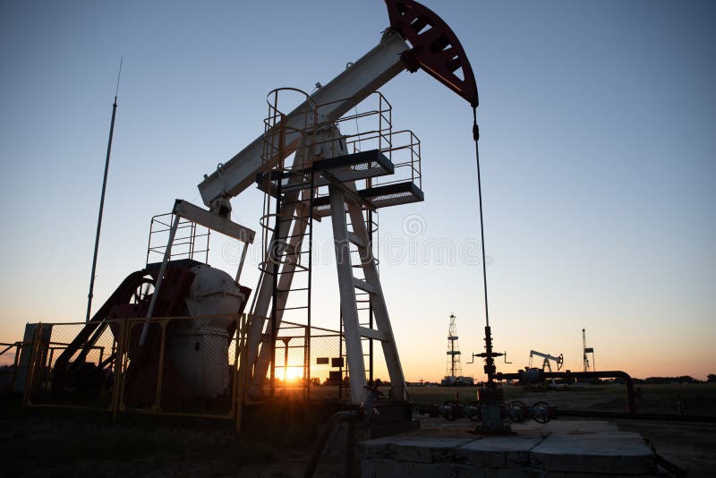 Oil Pump on orange sunset. stock photo. Image of oilfield - 194455810