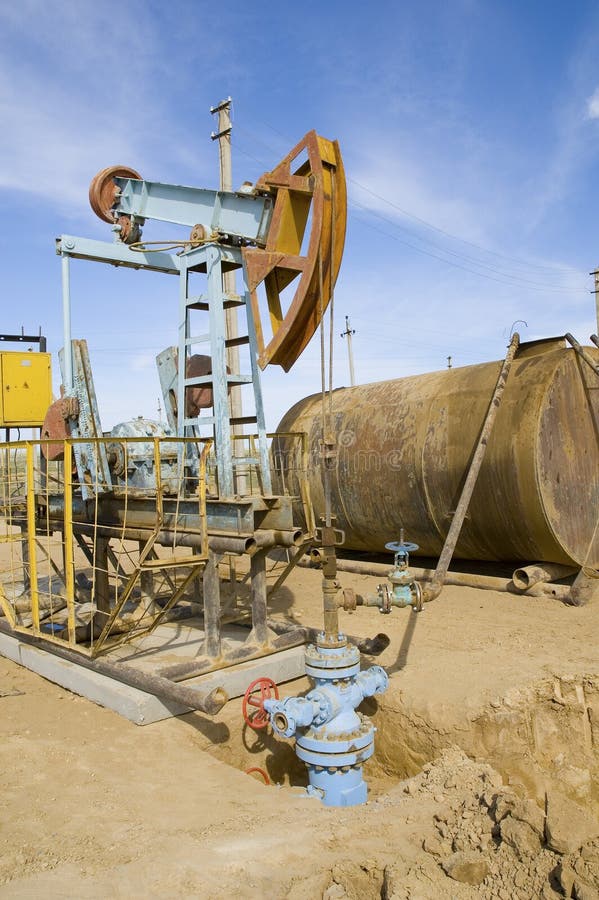 Oil Pump Under the Sunrise Sunset Sky. Oil Pumpjack Winter Working ...
