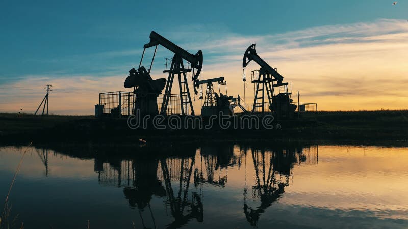Pumping Oil Rig at Sunset. Pump Jack Extracting Crude Oil from a Oil ...