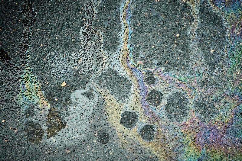 Oil Remnants on Wet Pavement Create Vibrant Patterns in Different Hues ...