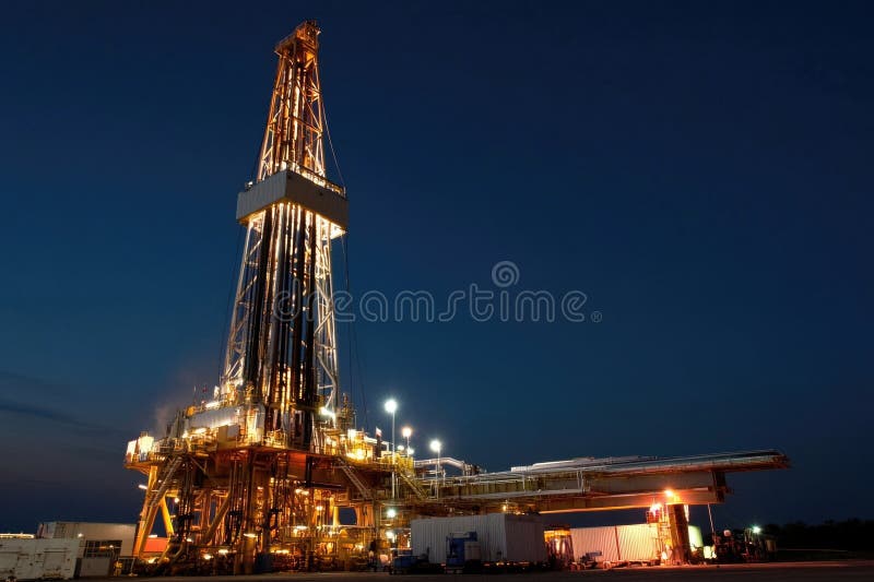 An Oil Rig Operating at Night in a Vast Field Stock Image - Image of ...