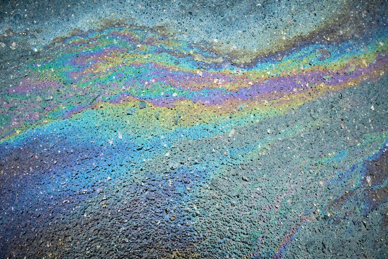 Oil Slick Creates Vibrant Colors on a Pavement Surface during Daylight ...