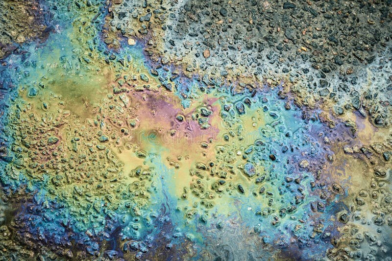 Oil Slick Creates Vibrant Patterns on Wet Asphalt Surface during a ...