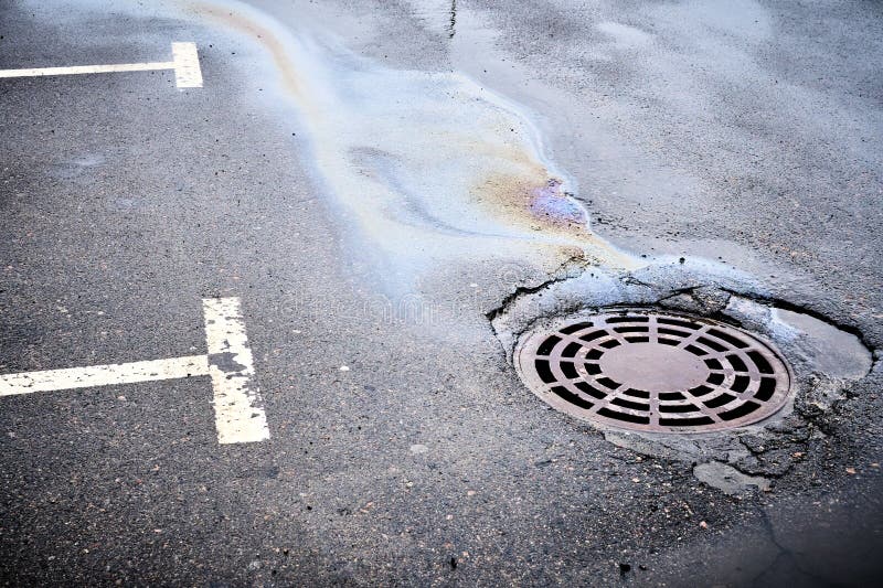 An Oil Slick of Gasoline or Oil on an Asphalt Road Flows into a Storm ...