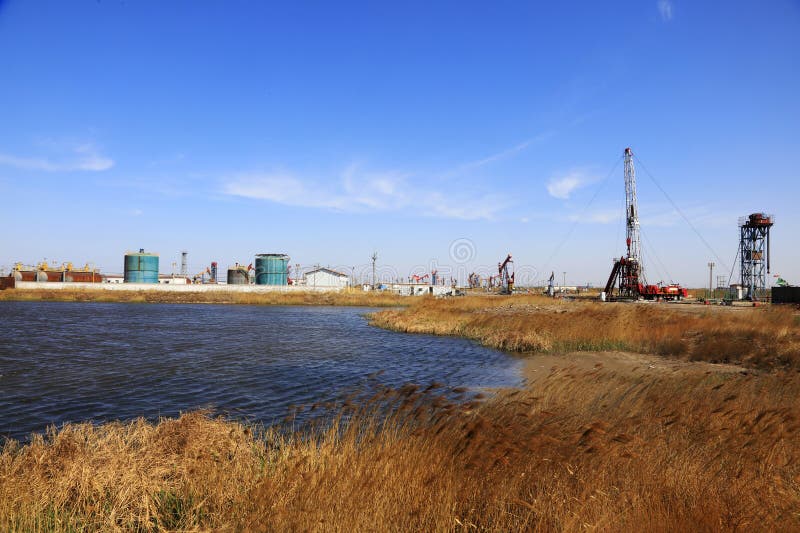 Oil storage tanks and pond stock image. Image of fields - 364851561
