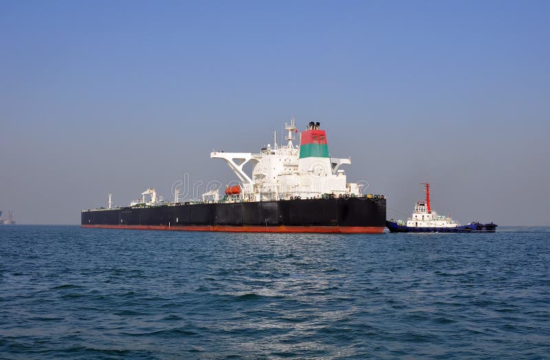Oil tanker and a tugboat stock photo. Image of import - 3342594