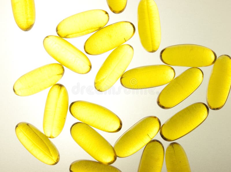 Oil vitamin yellow pills stock image. Image of medicine - 16379085
