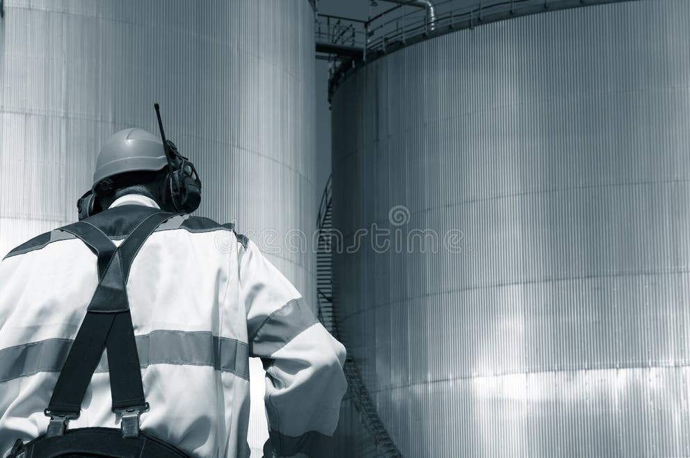 Oil worker and fuel tanks stock photo. Image of storage - 5351074