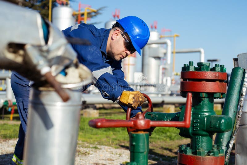 Oil Worker Turning Valve on Oil Rig Stock Photo - Image of outdoors ...