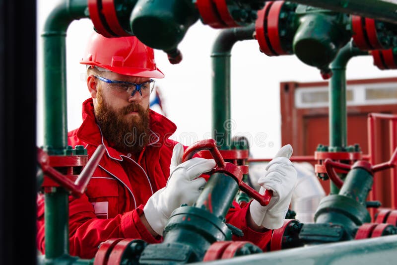 Oil Worker Turning Valve on Oil Rig Stock Photo - Image of ...