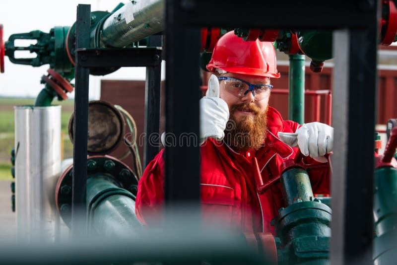 Oil Worker Turning Valve on Oil Rig Stock Image - Image of industry ...