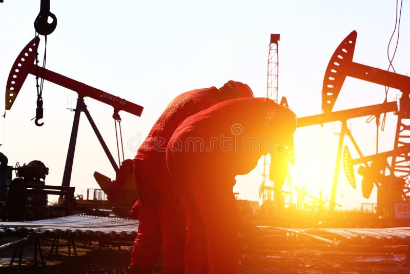 The oil workers at work stock image. Image of derrick - 220439911
