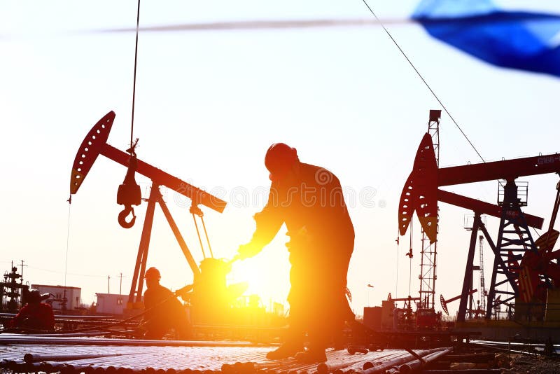 The oil workers at work stock image. Image of field - 220439919