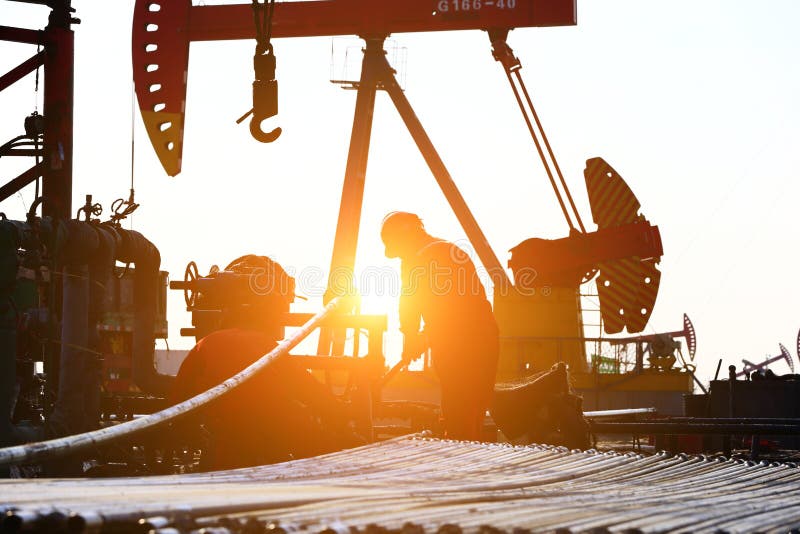 The oil workers at work stock photo. Image of profession - 220440000