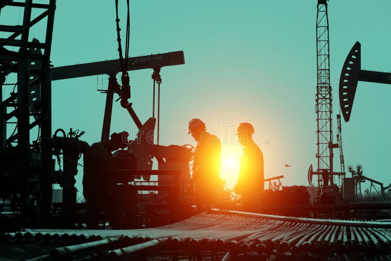 The oil workers at work stock photo. Image of crude - 220440504
