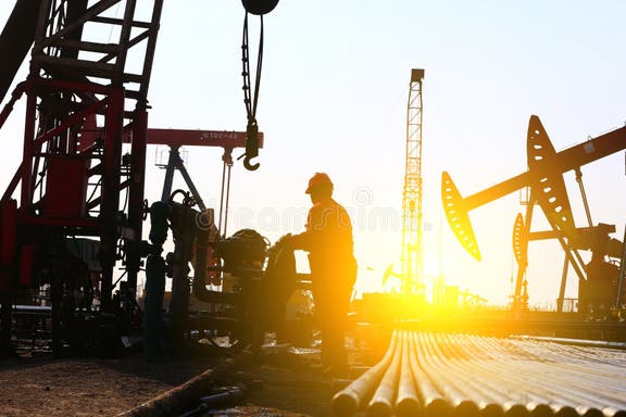 The oil workers at work stock image. Image of evening - 346430737