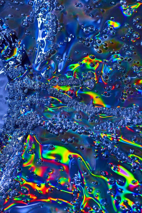 Oily Surface with Rainbow Burst of Color and Streams of Bubbles in ...