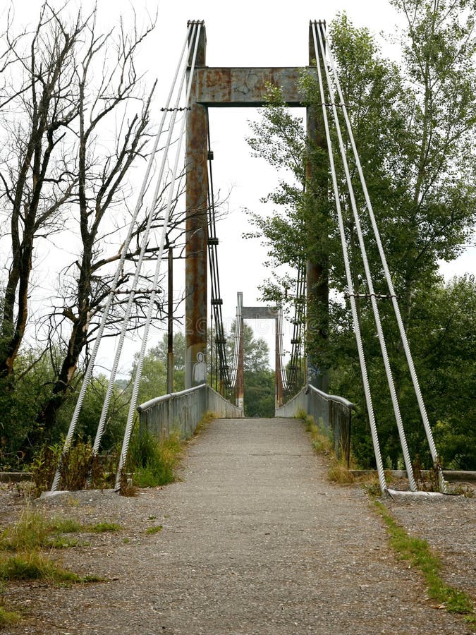 An Old Abandoned Cable-stayed Bridge Over a Small River. Stock Image ...