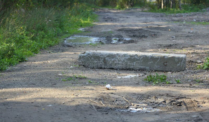 An Old Abandoned Dirt Road is Blocked by a Concrete Block Stock Photo ...