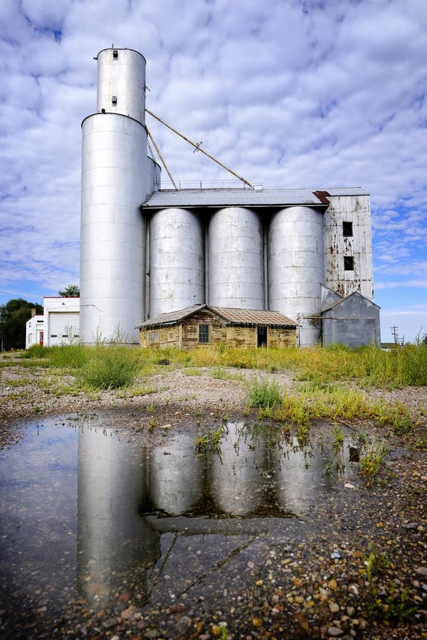 Old Abandoned Granary Grain Silo in Rural Area Blue Sky and Dramatic Clouds Stock Photo - Image ...