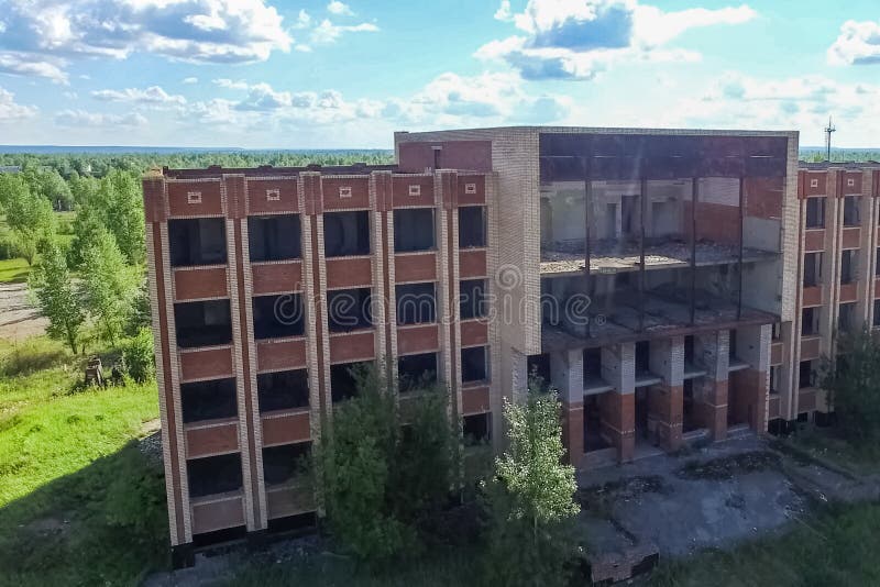 An Old Abandoned High Rise Building, Overgrown with Trees and Gr Stock ...