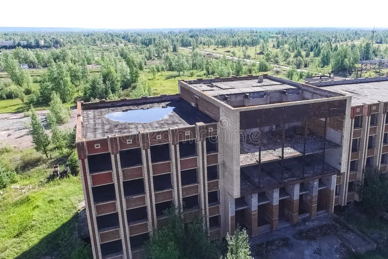 An Old Abandoned High Rise Building, Overgrown with Trees and Gr Stock ...