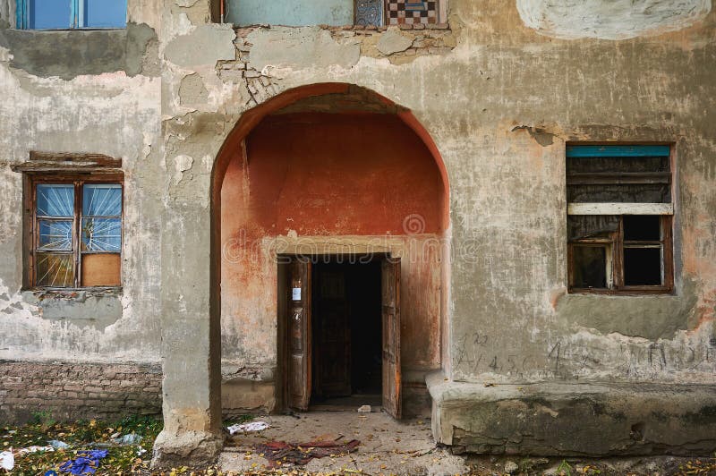 An Old Abandoned House with Broken Windows and Cracks in the Wall ...