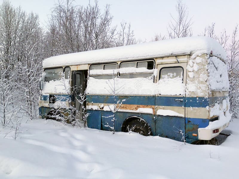An Old Abandoned Rusty Bus Stands Empty in a Snowdrift in Winter. Stock ...