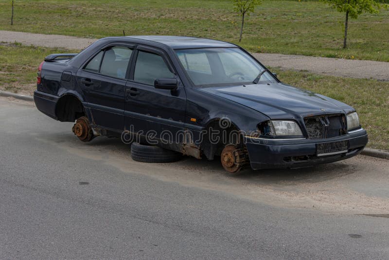 Old Abandoned Rusty Car without Wheels on the Side of the Road Stock ...