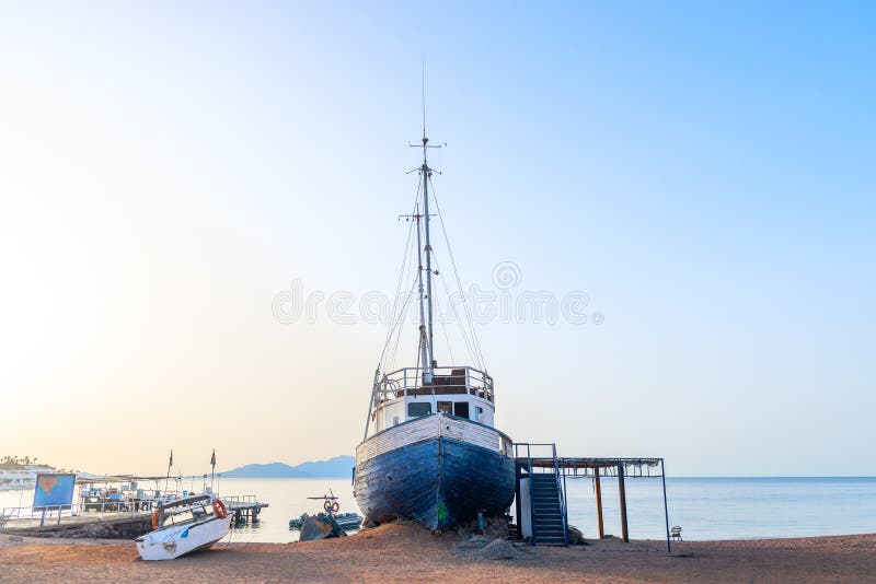 An Old Abandoned Ship Stands on the Beach of a Red Sea Resort Stock ...