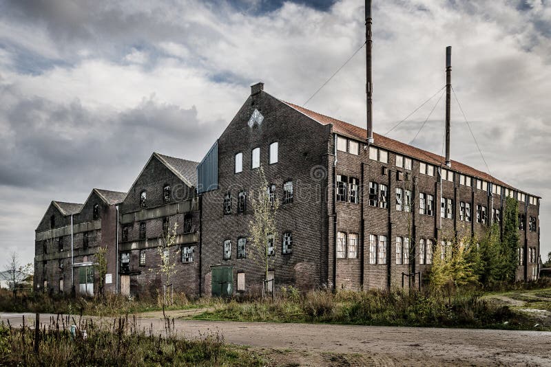 Old Abandoned Stone Building with Broken Windows Under the Dark Cloudy ...