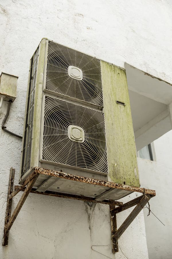 An Old and Aging Split Type Air Conditioner Condenser Mounted on the ...