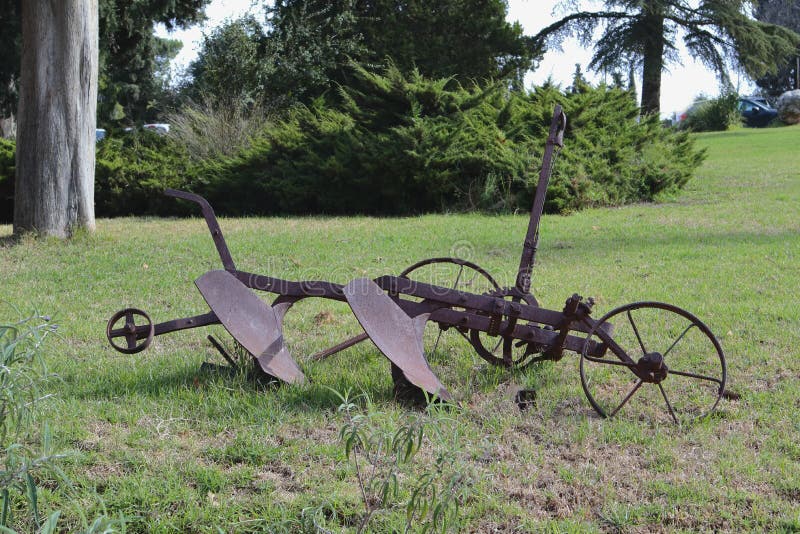 Old Agriculture Equipment. Plow in the Green Grass Stock Image - Image ...