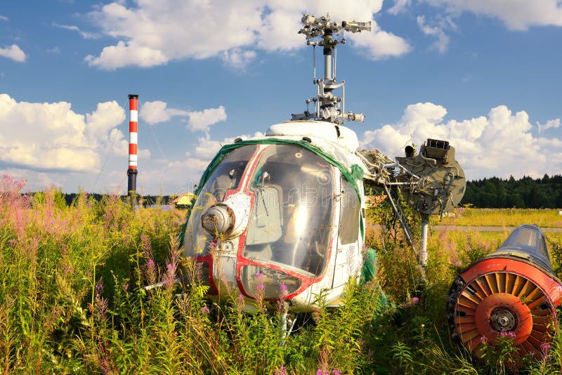 Old Airplane Fuselage and Rusty Helicopters on Green Grass Stock Image ...