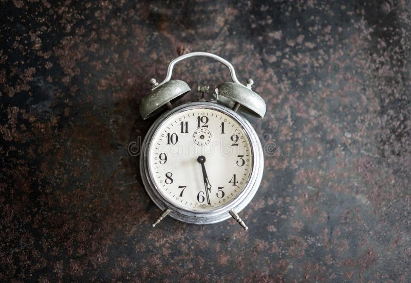 Old Alarm Clock on the Ancient Iron Table. Stock Photo - Image of clock ...
