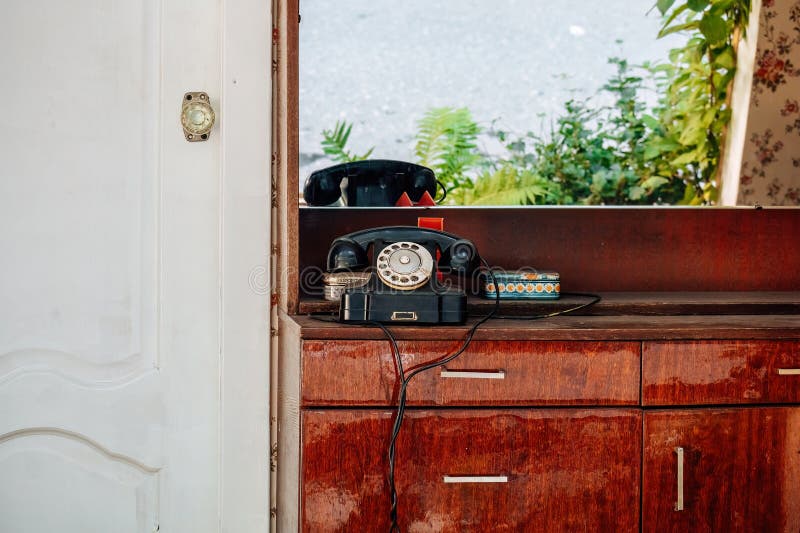 Old Analog Disk Phone on a Wooden Chest of Drawers in Retro Style Stock ...